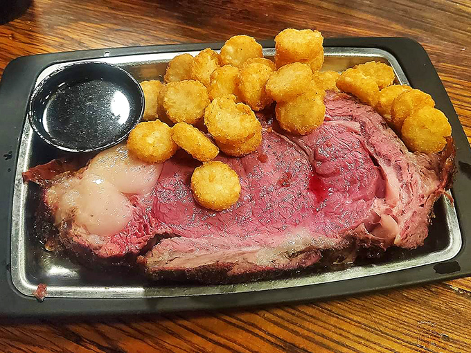 Holy cow! This prime rib isn't just a meal, it's a meaty masterpiece. Perfectly pink, generously portioned, and flanked by golden tater tots fit for a cattle baron.