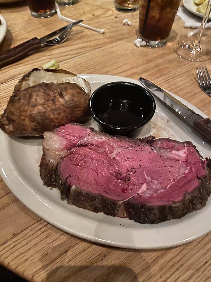 This isn't just prime rib &ndash; it's a monument to beef perfection, accompanied by its soulmate: a loaded baked potato wearing a tuxedo of toppings.