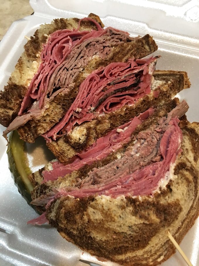 Holy corned beef, Batman! This Reuben is stacked higher than a Jenga tower. It's a sandwich that demands a strategy... and possibly a fork.