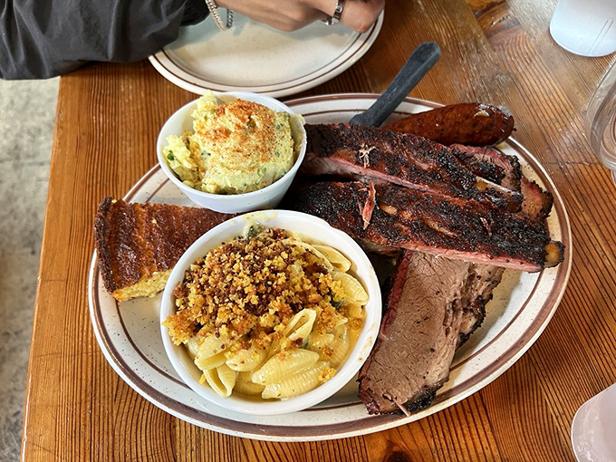 Behold, the carnivore's dream team! Ribs, brisket, and sides join forces to create a plate that's more satisfying than solving a crossword puzzle.