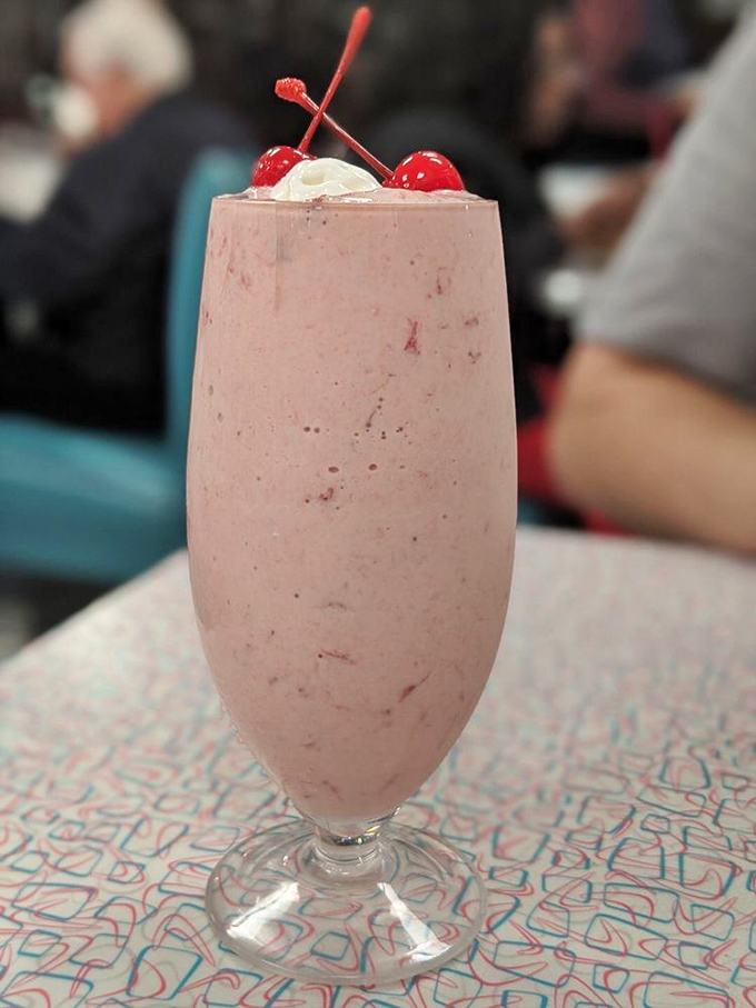 Pretty in pink and oh-so-sweet! This strawberry milkshake is like summer in a glass, topped with a cherry on cloud nine.