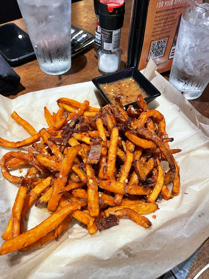 The star attraction arrives! These sweet potato fries aren't just a side dish&mdash;they're the main event, with bacon bits playing the perfect supporting role.
