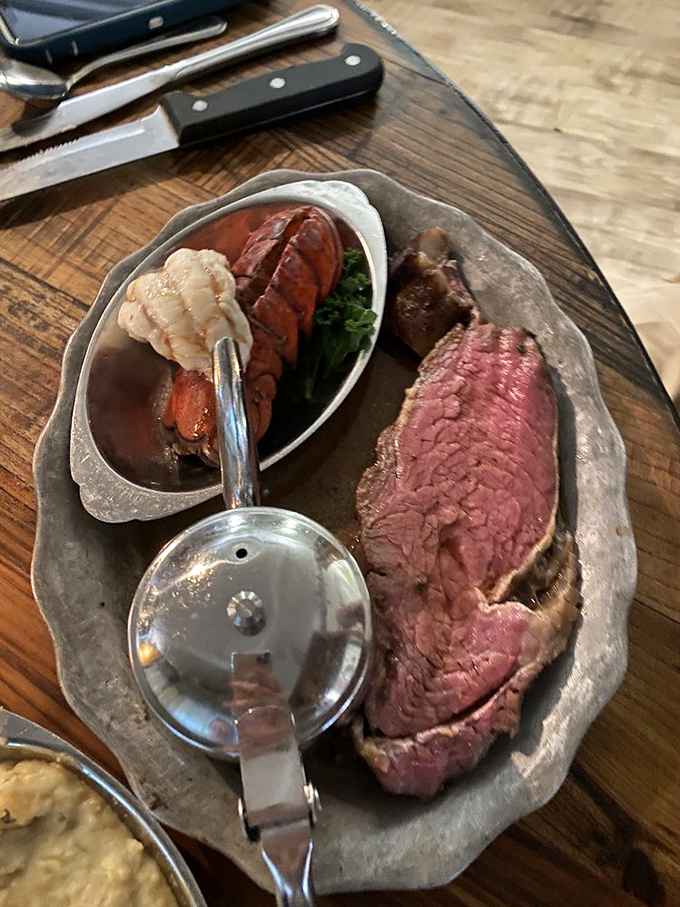 The ultimate surf 'n' turf showdown: A prime rib so perfect it could make a vegetarian weep, paired with a lobster tail that's ready for its close-up.