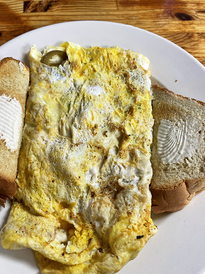 Behold, the veggie omelet! It's so fluffy, it might float away if not anchored by that hearty toast. A garden party in every bite.
