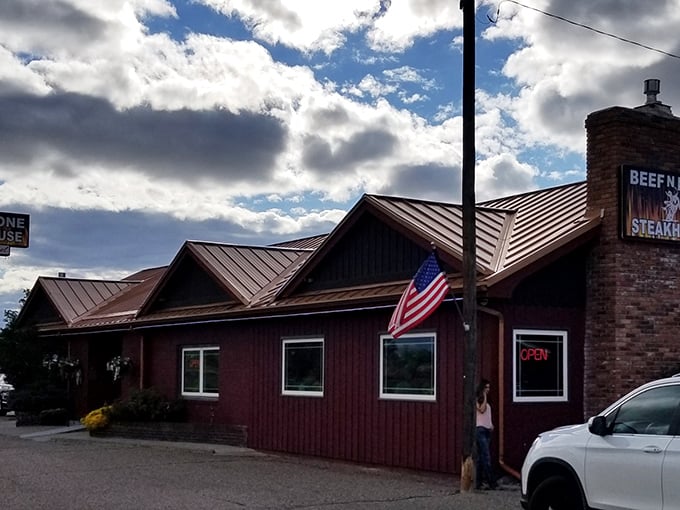 Red on the outside, flavor explosion on the inside. This roadside gem proves you can't judge a steakhouse by its siding.