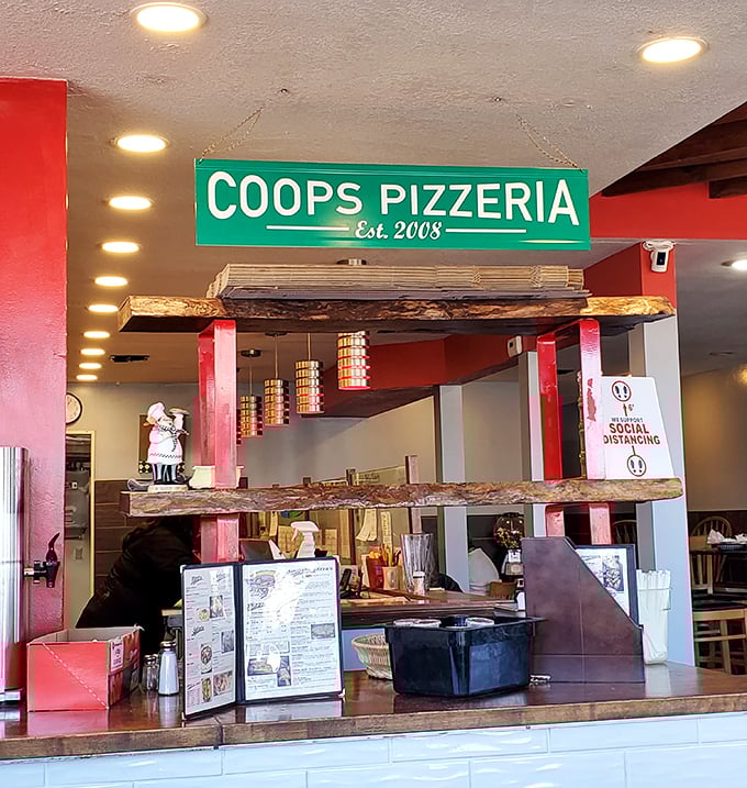 Inside Coop's, that green sign marks the spot where pizza dreams come true since 2008.