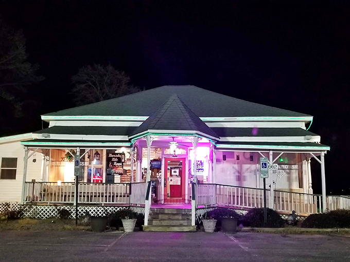 Night falls, but the Village Steakhouse shines bright. It's where comfort food meets fine dining in a warm, purple glow.