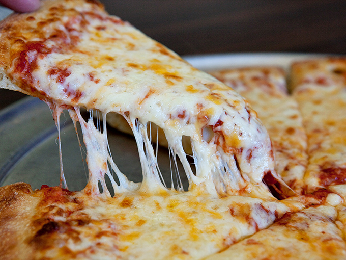 Cheese pulls for days! This slice is stretchier than your favorite pair of post-Thanksgiving pants, and twice as satisfying.