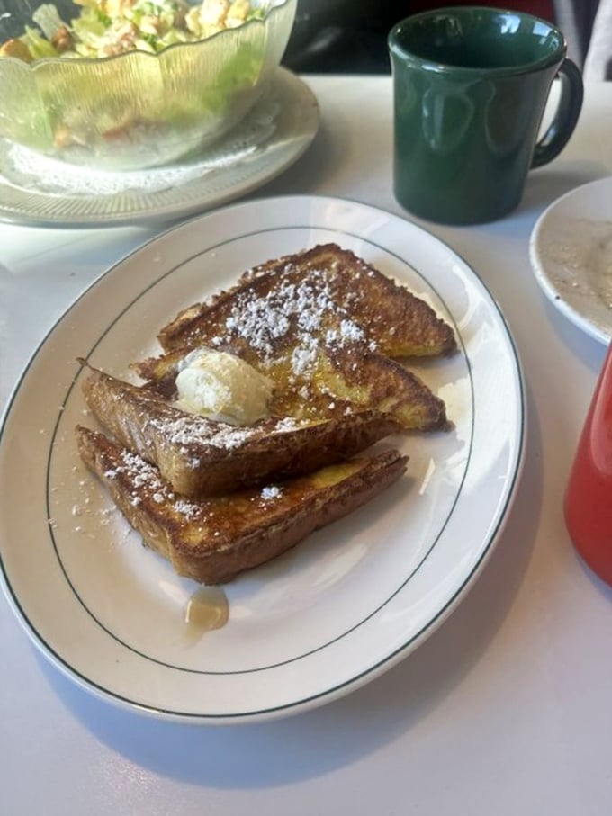 French toast that's been dipped, griddled, and powdered to perfection. The butter melting on top is nature's way of saying "Good morning!"