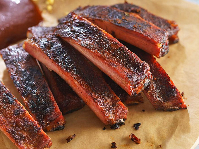 Behold, the holy grail of barbecue! These hickory-smoked ribs are so tender, they practically fall off the bone with a stern look.