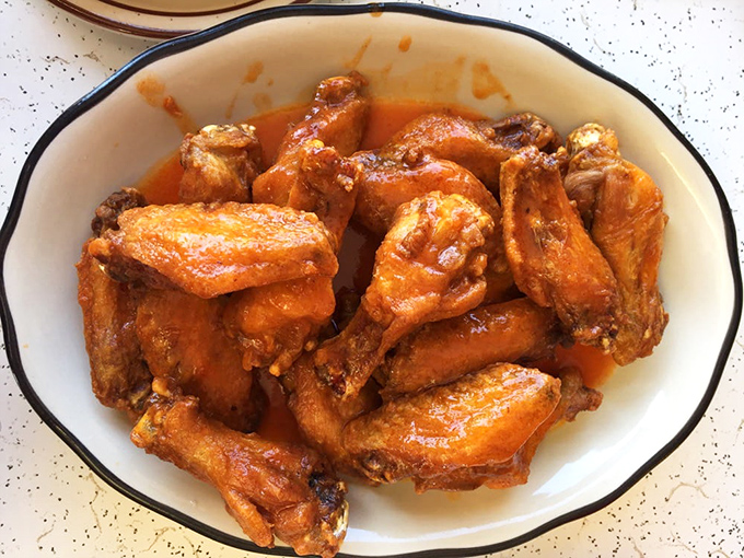 Medium wings, maximum flavor! These golden beauties are the Goldilocks of the wing world - just right.
