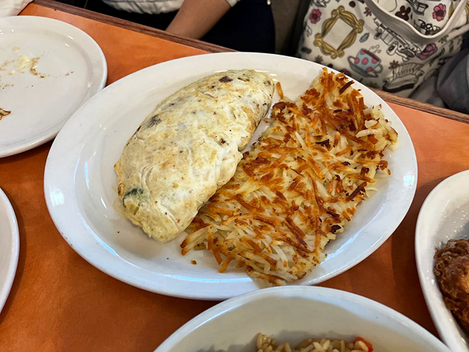 The Odd Couple of breakfast: a golden omelet snuggling up to its crunchy hash brown roommate. A match made in brunch heaven!