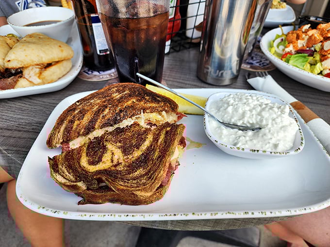Meet the Reuben that launched a thousand food comas. This swirl of marbled rye cradles a mountain of corned beef, ready to conquer your hunger.