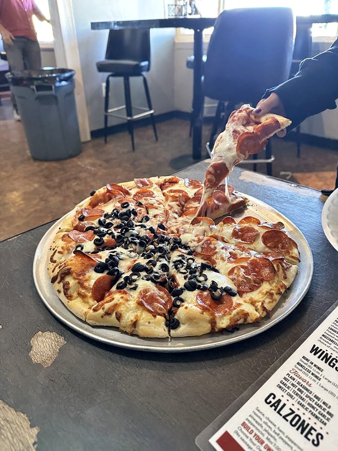 Half and half heaven! One side's a veggie lover's dream, the other's an olive enthusiast's paradise.