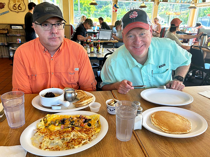 The dynamic duo of breakfast bliss: a cheese-laden omelet cozying up to crispy hash browns. Name a more iconic pair!