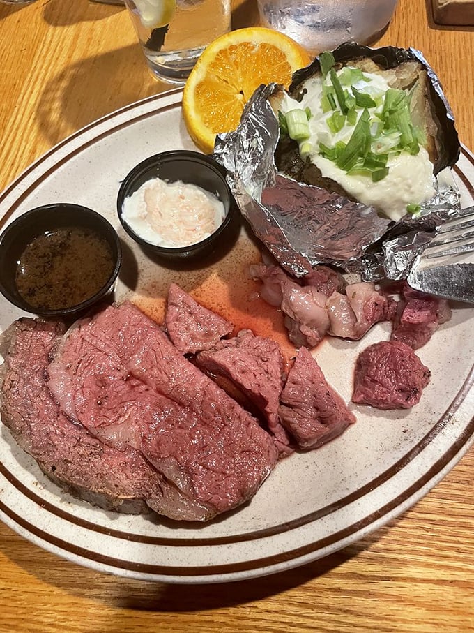 Behold, the prime rib special! A slice of beefy perfection alongside a loaded baked potato. It's like a hug for your stomach, only better.