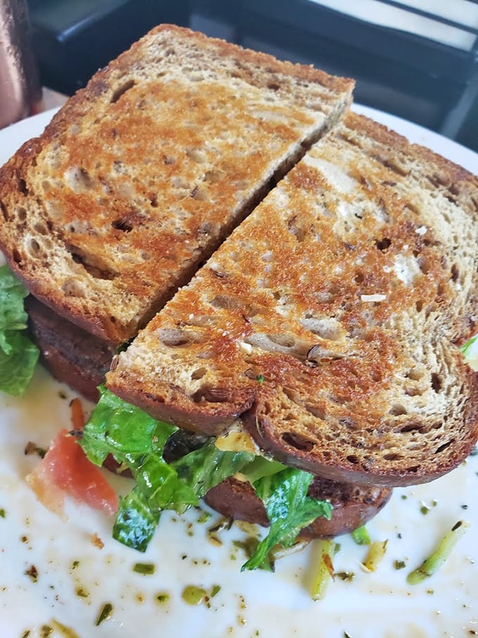 Who knew a simple sandwich could look so inviting? This beauty is like a well-dressed salad that decided to get cozy between two slices of toasted perfection.