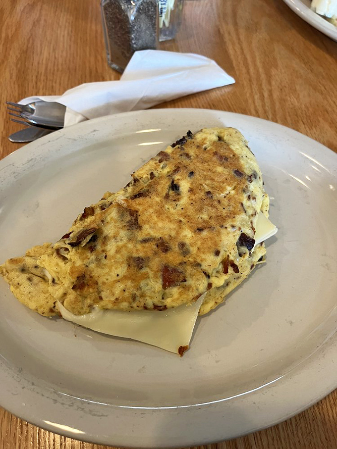 This bacon and cheese omelet is so perfectly folded, it could teach origami classes. It's a cheesy, bacony envelope of joy that your taste buds will want to RSVP to.
