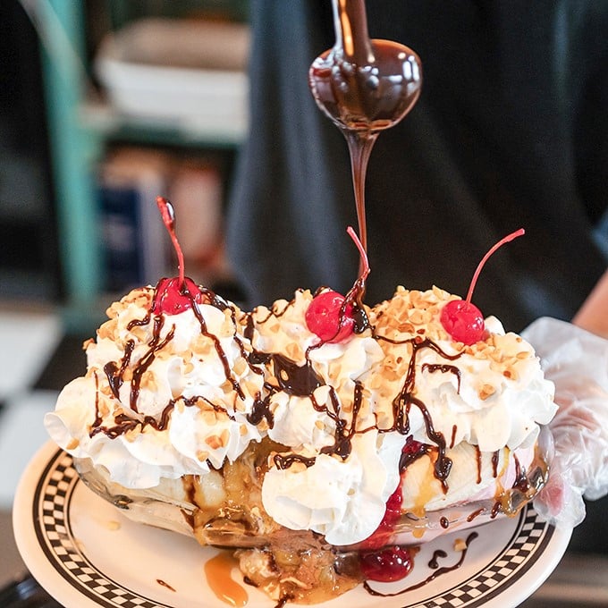 Behold, the Everest of desserts! This banana split is a towering testament to the magic that happens when ice cream, fruit, and chocolate sauce join forces.