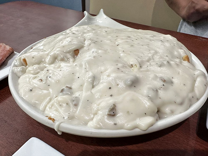 Behold, the Everest of breakfast! This mountain of biscuits and gravy is so tempting, you'll need an expedition team to conquer it.