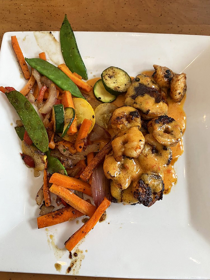 Blackened salmon that's hotter than a Dakota summer, cooled by a medley of grilled veggies. A perfect balancing act!