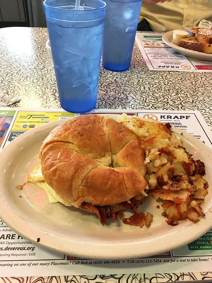 The breakfast sandwich that puts your sad desk lunch to shame. It's like a hug for your taste buds, served on a croissant.