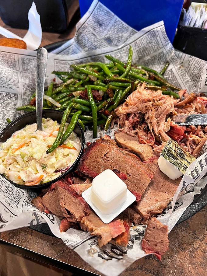 The holy trinity of barbecue: brisket with that perfect smoke ring, pulled pork in all its glory, and green beans that actually deserve space on the plate.
