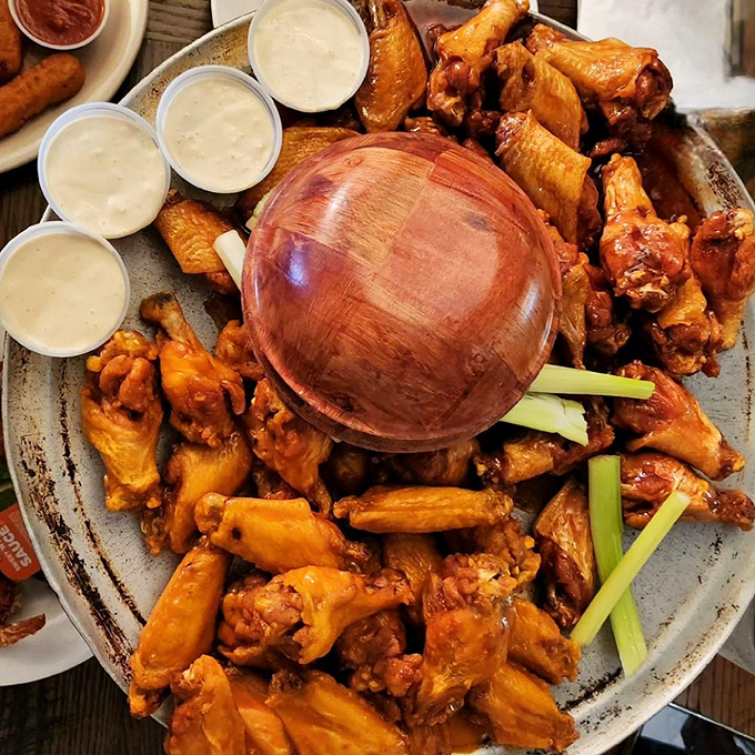 A mountain of wings surrounded by blue cheese cups &ndash; like a delicious game of culinary Jenga that nobody minds losing.