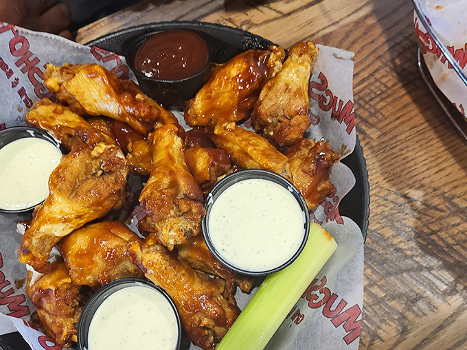 The holy trinity of wing perfection: crispy, saucy, and paired with cool dips. It's like a flavor fiesta in your mouth!