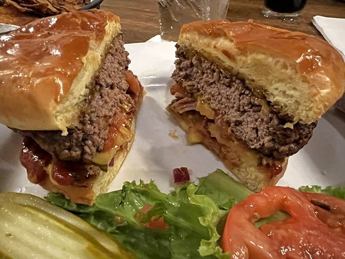 Behold the burger that launches a thousand napkins! This perfectly bisected beauty reveals the juicy interior where cheese meets beef in perfect harmony.