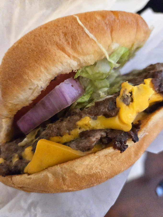 Cheese, glorious cheese! This burger's got layers like a soap opera, but with 100% more deliciousness.