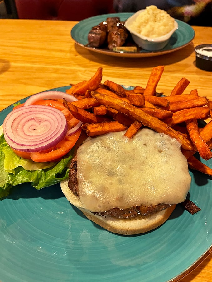 This isn't just a cheeseburger &ndash; it's a tower of temptation. With those crispy fries and fresh toppings, it's the kind of burger that makes you forget salads exist.