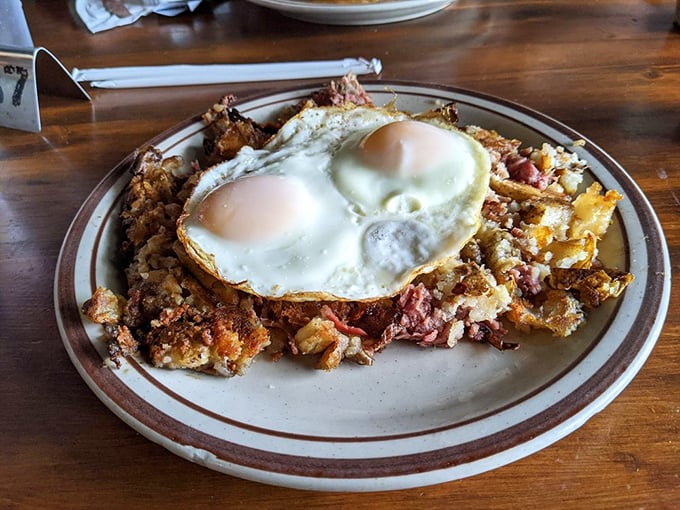 A breakfast that's worth getting out of bed for! This hearty plate of corned beef hash topped with sunny-side-up eggs is like a warm hug for your stomach.