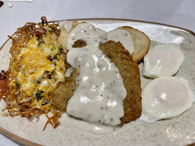Country fried steak smothered in pepper gravy alongside perfectly cooked eggs&mdash;this plate doesn't just feed you, it hugs you from the inside.
