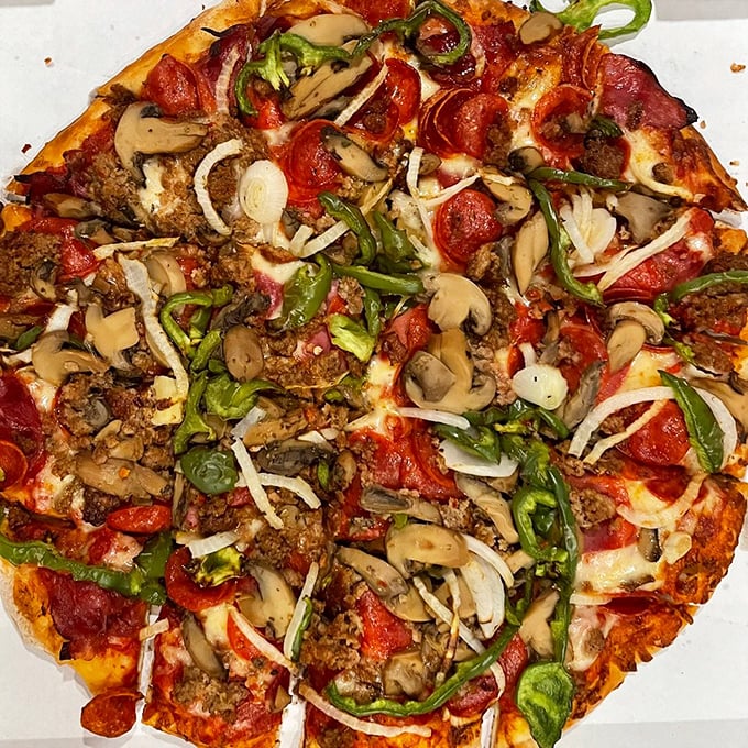 Talk about a slice of heaven! This deluxe pizza is so packed with goodies, it's practically a balanced meal. Your diet can take a day off.