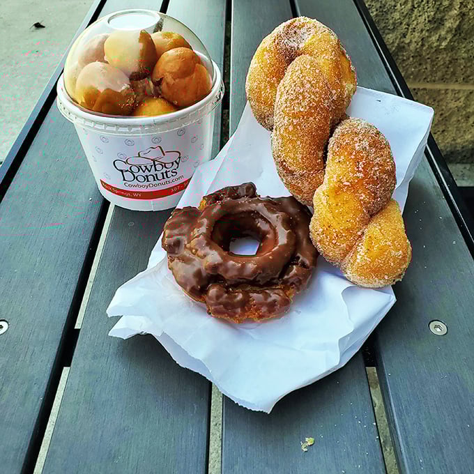 A trifecta of temptation! Donut holes, chocolate-glazed rings, and cinnamon twists&mdash;it's like the Triple Crown of breakfast indulgence.