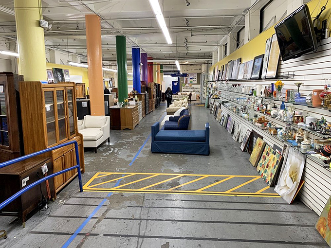 The furniture section stretches into infinity, with colorful pillars guiding you through a maze of sofas, cabinets, and framed art waiting for forever homes.
