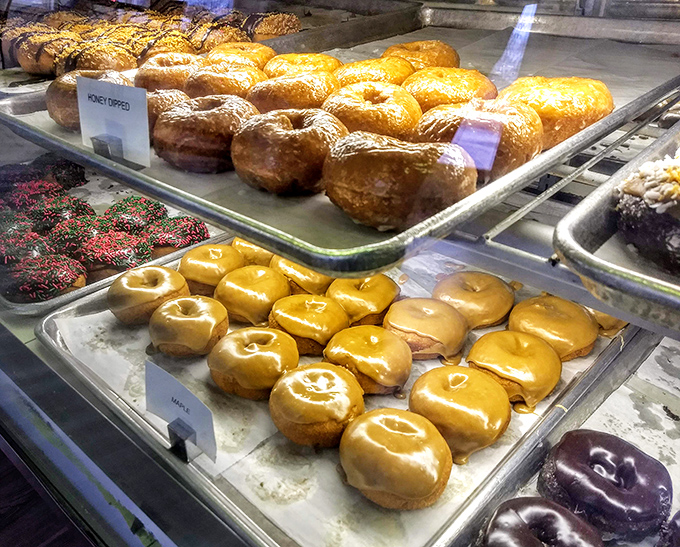 Golden delights await! These honey-dipped and maple donuts shine brighter than a retiree's golf clubs on a sunny day.