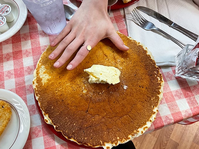 The Giant Pancake lives up to its name, spanning the entire plate with a golden-brown surface that's the perfect canvas for a melting pat of butter.