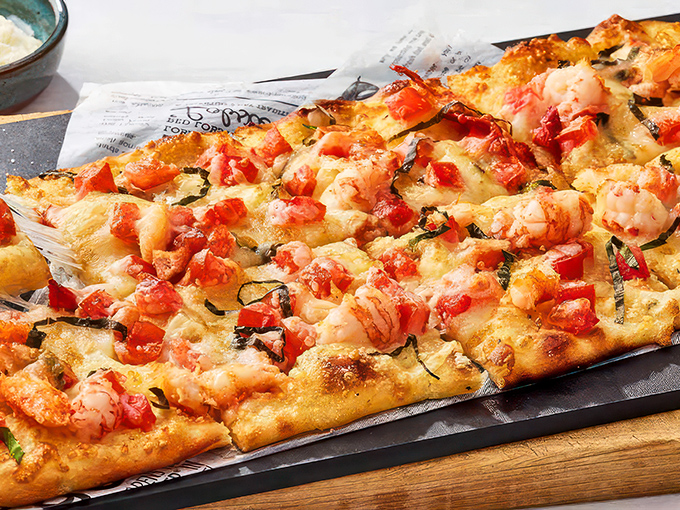 Pizza meets the ocean in this flavor explosion! It's like a beach party where the lobster and shrimp decided to crash - and we're all invited.