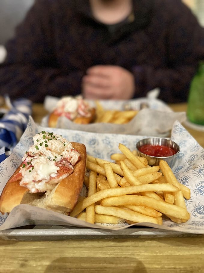The lobster roll that launched a thousand ships... or at least a thousand satisfied smiles. Paired with crispy fries, it's a match made in heaven.