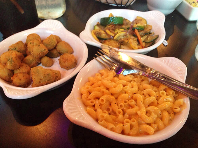 The holy trinity of Southern sides: mac and cheese, crispy potatoes, and veggies. It's like a warm hug for your taste buds.