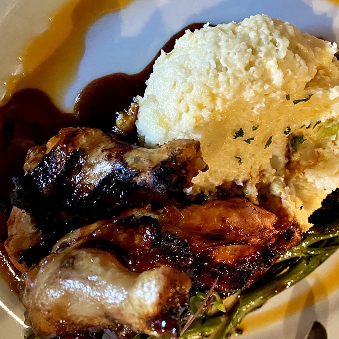 The close-up that launched a thousand road trips: silky mashed potatoes meeting caramelized chicken in a pool of savory jus.