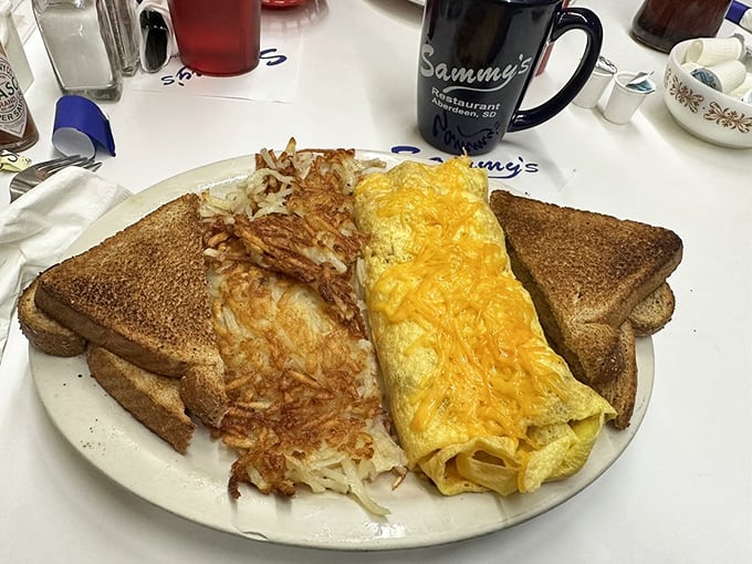 Forget the golden ratio; this plate has achieved the perfect balance of omelet, hashbrowns, and toast. A breakfast trifecta!