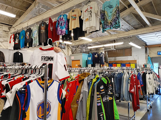 Sports jerseys and graphic tees from another era hang like colorful banners, celebrating teams and tours that have long since packed up.