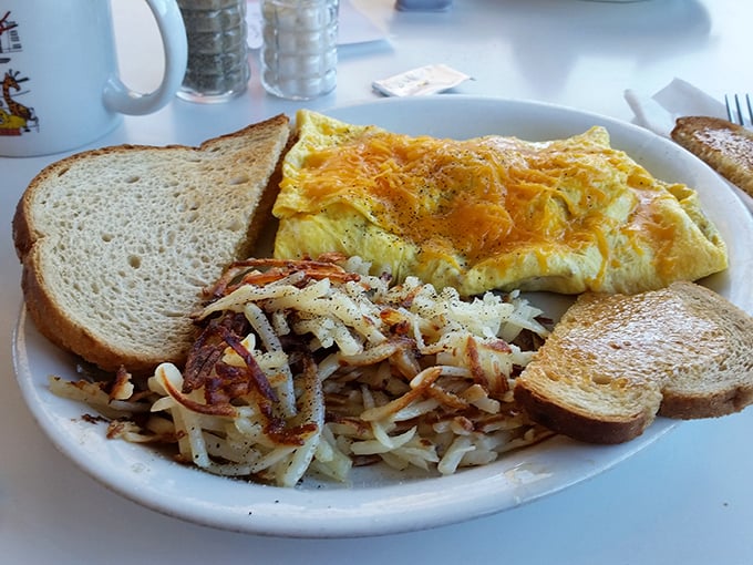 This omelet is so fluffy, it might float away if not for that mountain of crispy hash browns anchoring it to the plate.