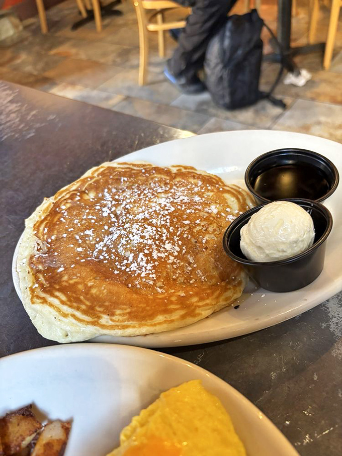 Pancake perfection! This golden disc of joy comes with a side of butter that's not fooling anyone about its diet-busting intentions.
