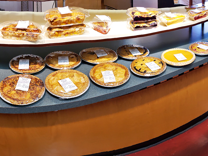 Heaven's waiting room looks suspiciously like this pie display. Each golden crust promises a different path to dessert nirvana.