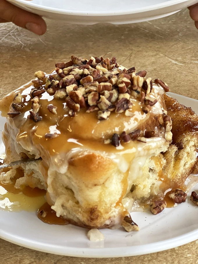 Behold, the cinnamon roll that launched a thousand road trips. Gooey, nutty, and caramel-drizzled – it's dessert masquerading as breakfast.