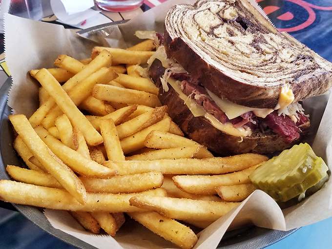 The Reuben, in all its marble rye glory, flanked by golden fries. It's not just a meal; it's a religious experience for your taste buds.